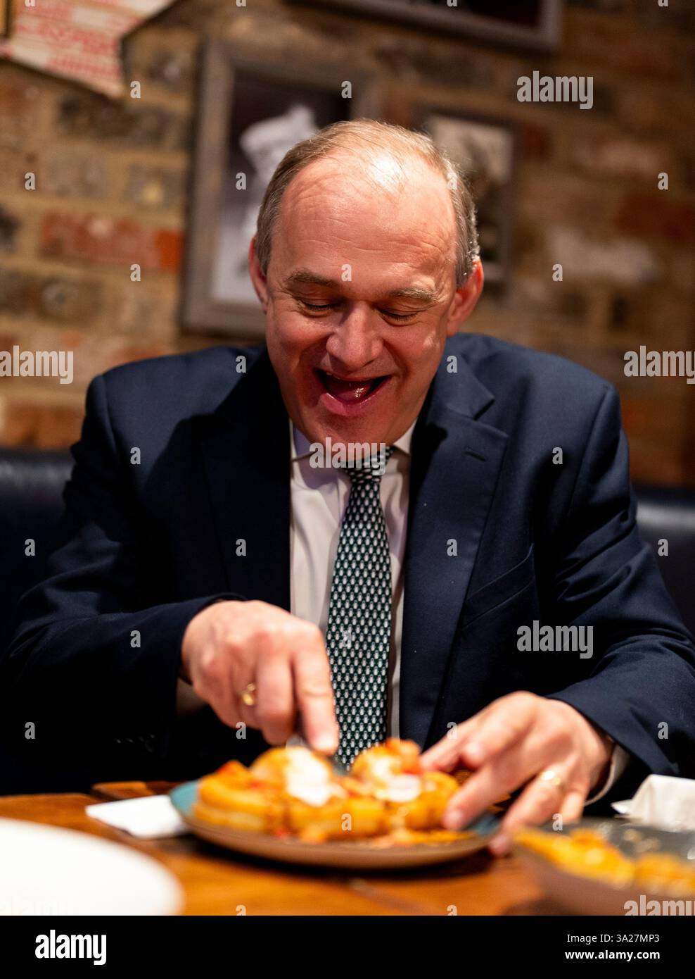Liberal Democrats leader Sir Ed Davey, eats some food at the Canadian ...