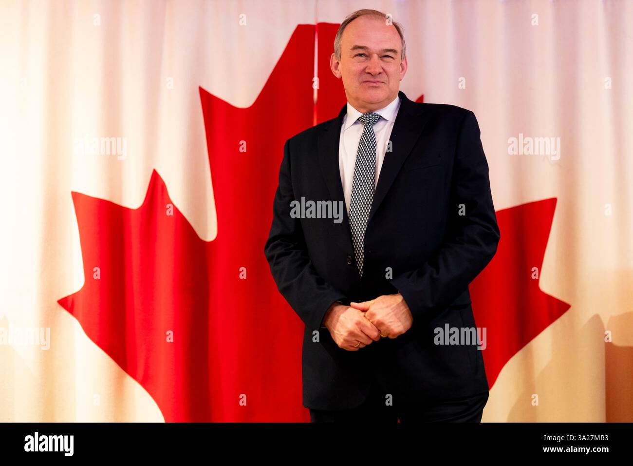 Liberal Democrats leader Sir Ed Davey, stands in front of a set of ...