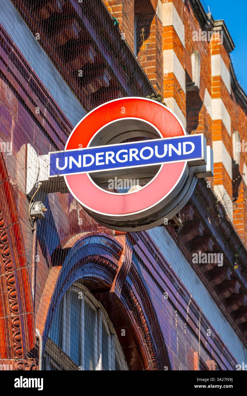 Bright red and blue sign marks the entrance to a London Underground ...