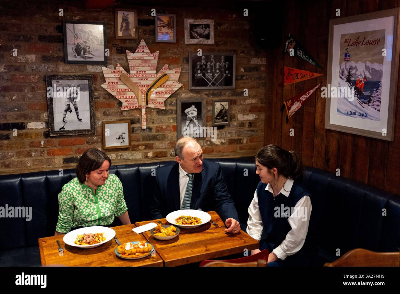 Liberal Democrats leader Sir Ed Davey, eats some food at the Canadian ...