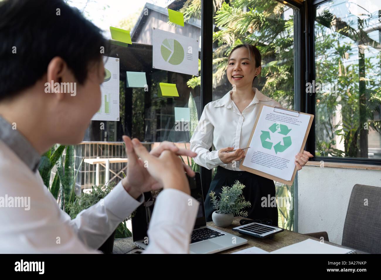 Green Innovations and Presentations. Team presenting eco-friendly ...