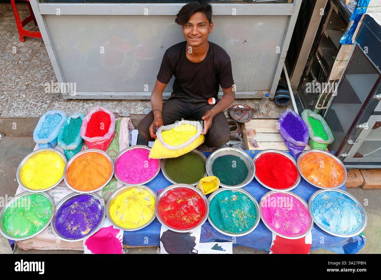 Vendor selling Gulal (coloured powder) for the Holi Festival in Rewa ...