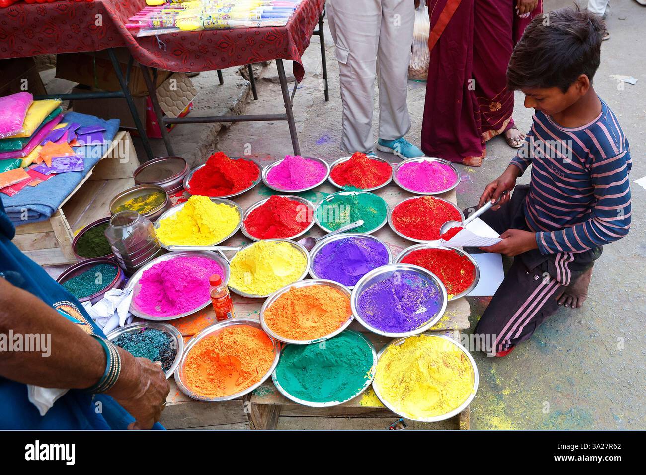 A child vendor selling Gulal (coloured powder) for the Holi Festival in ...