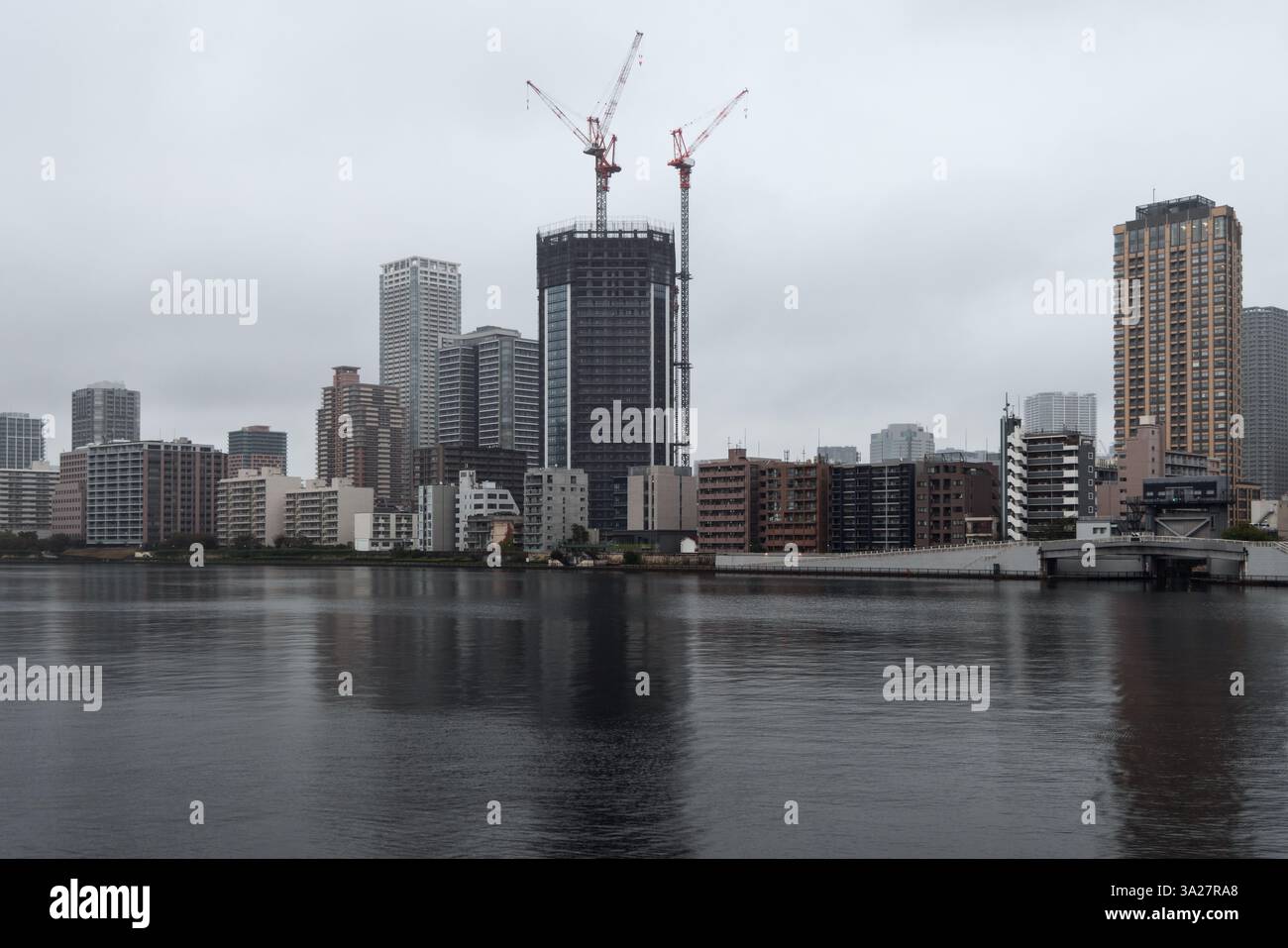 Urban view of Kachidoki, Tokyo, showing a developing skyscraper with ...