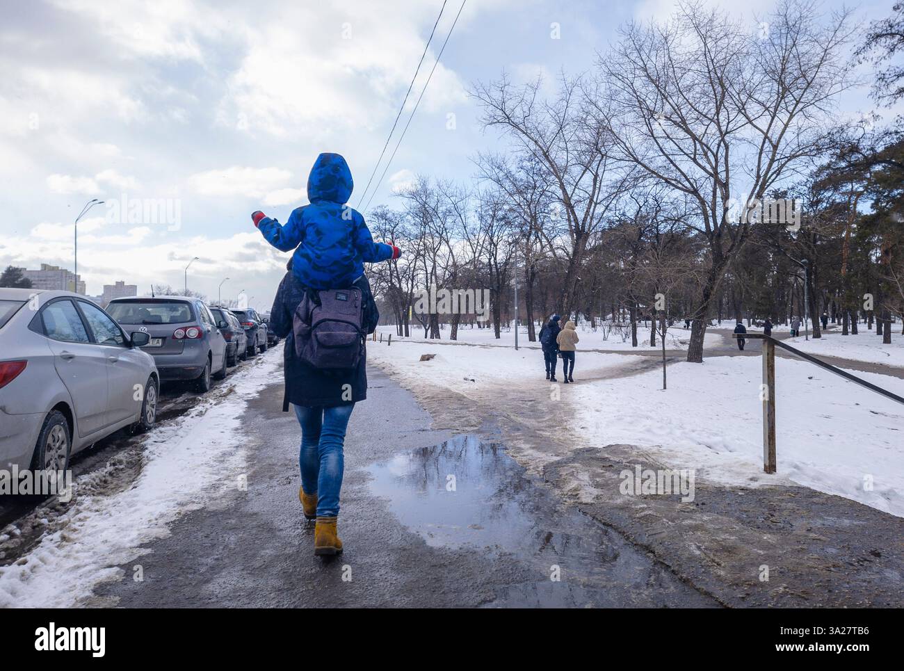 Kyiv, Ukraine - 2d March, 2025: People enjoy a brisk winter day, with one person joyfully ...