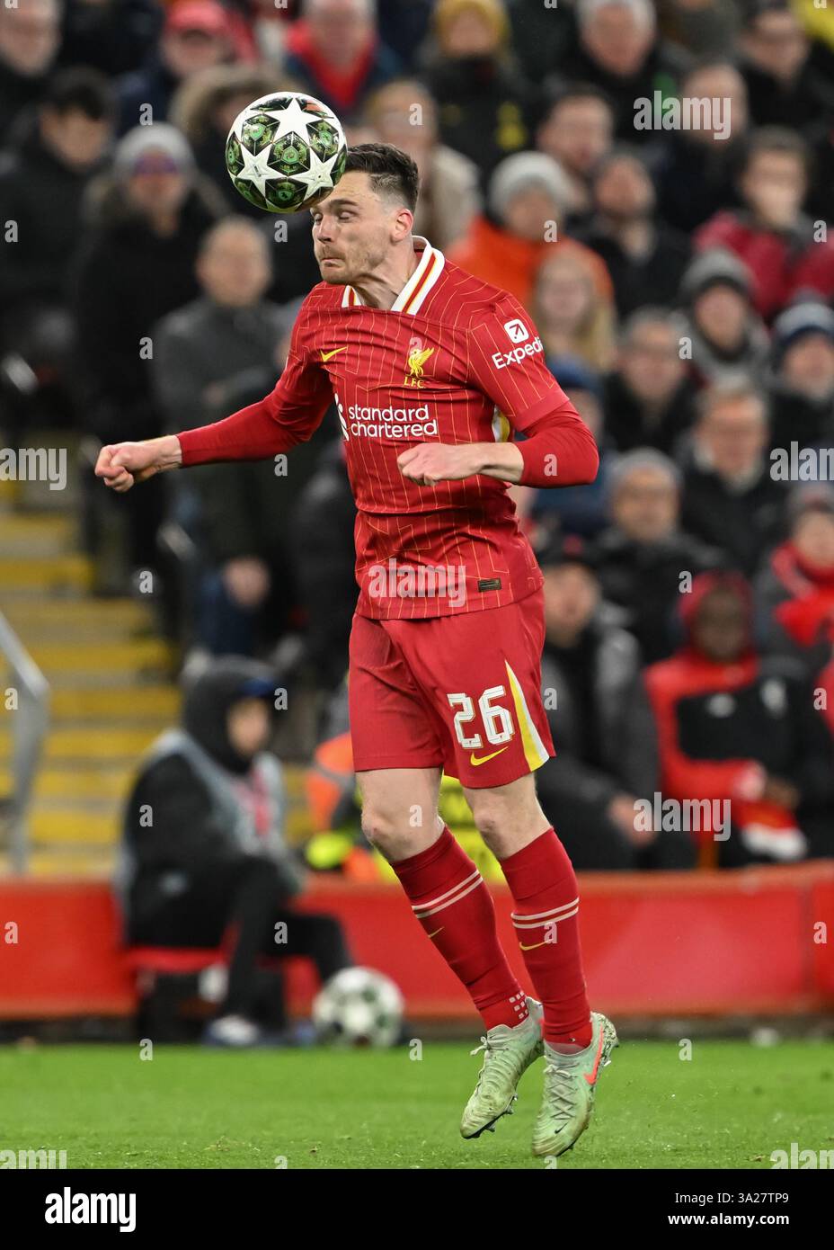 Liverpool, UK. 11th Mar, 2025. Andrew Robertson of Liverpool heads the ...