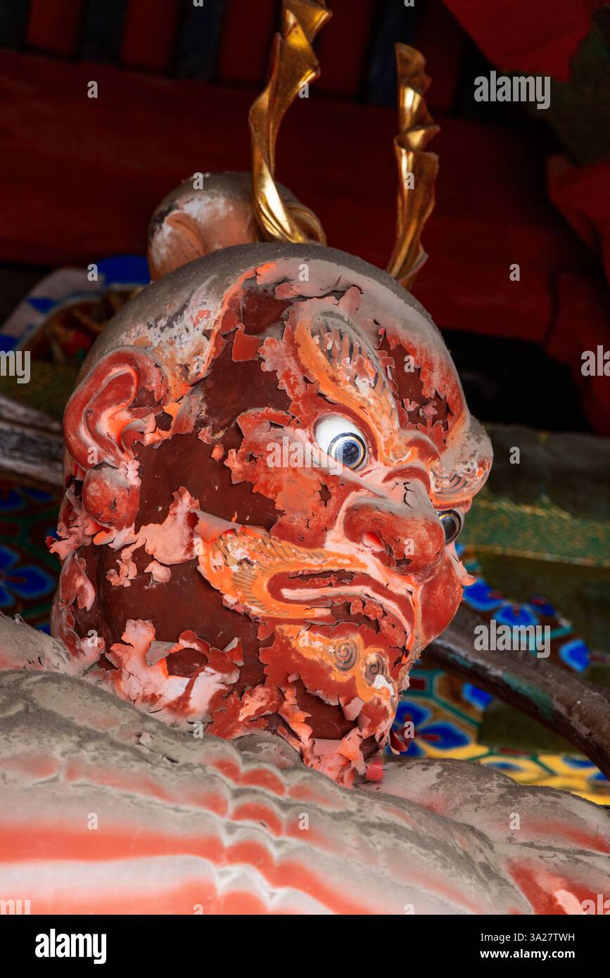 Portrait of a weathered Nio guardian statue at Toshogu Shrine in Nikko ...