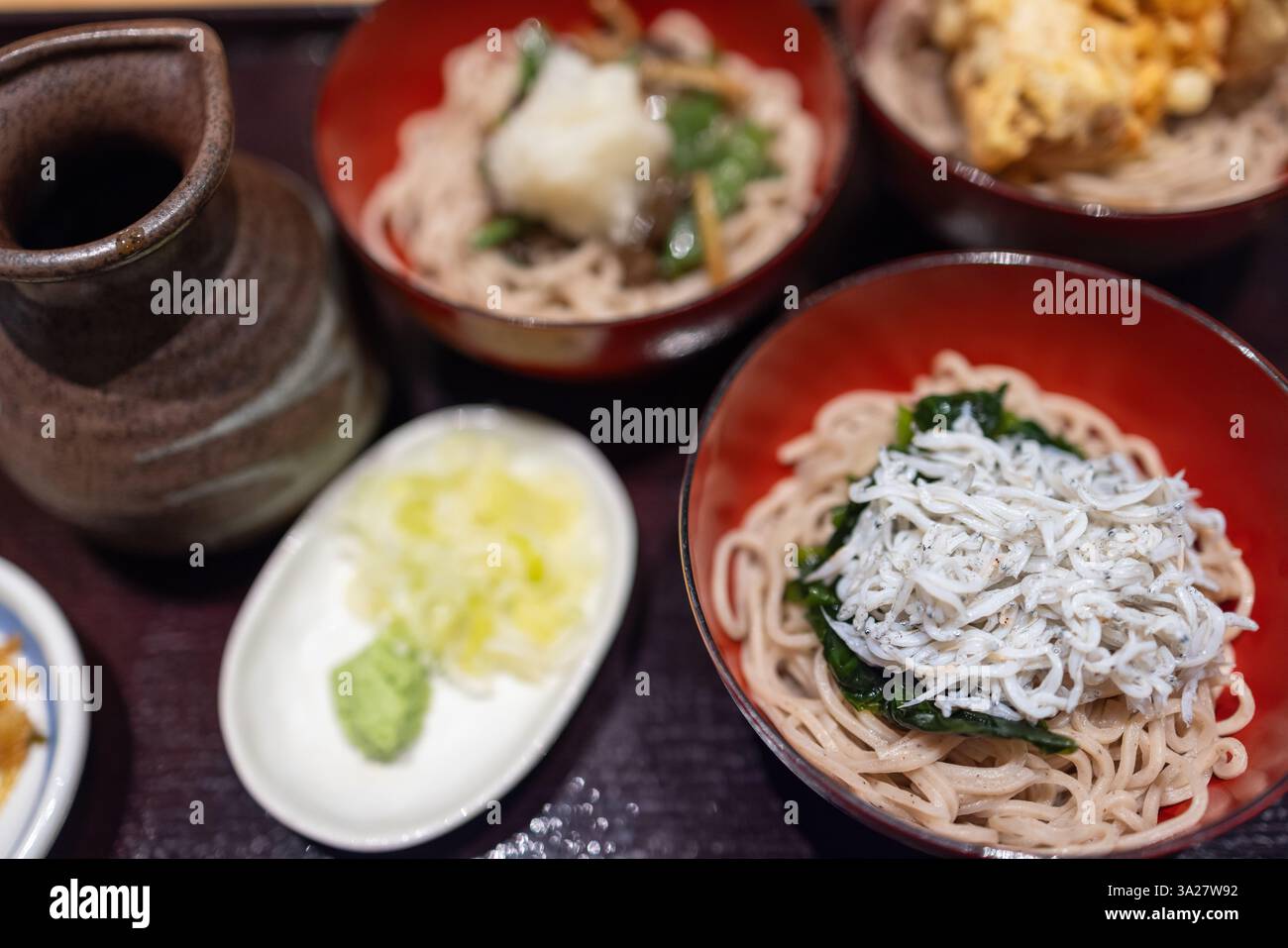 Japanese teishoku meal featuring soba noodles in red bowls with various ...