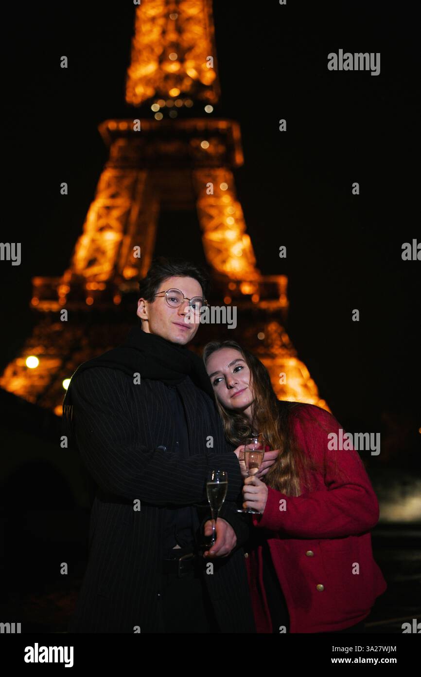 A romantic couple shares an intimate moment with champagne under the ...