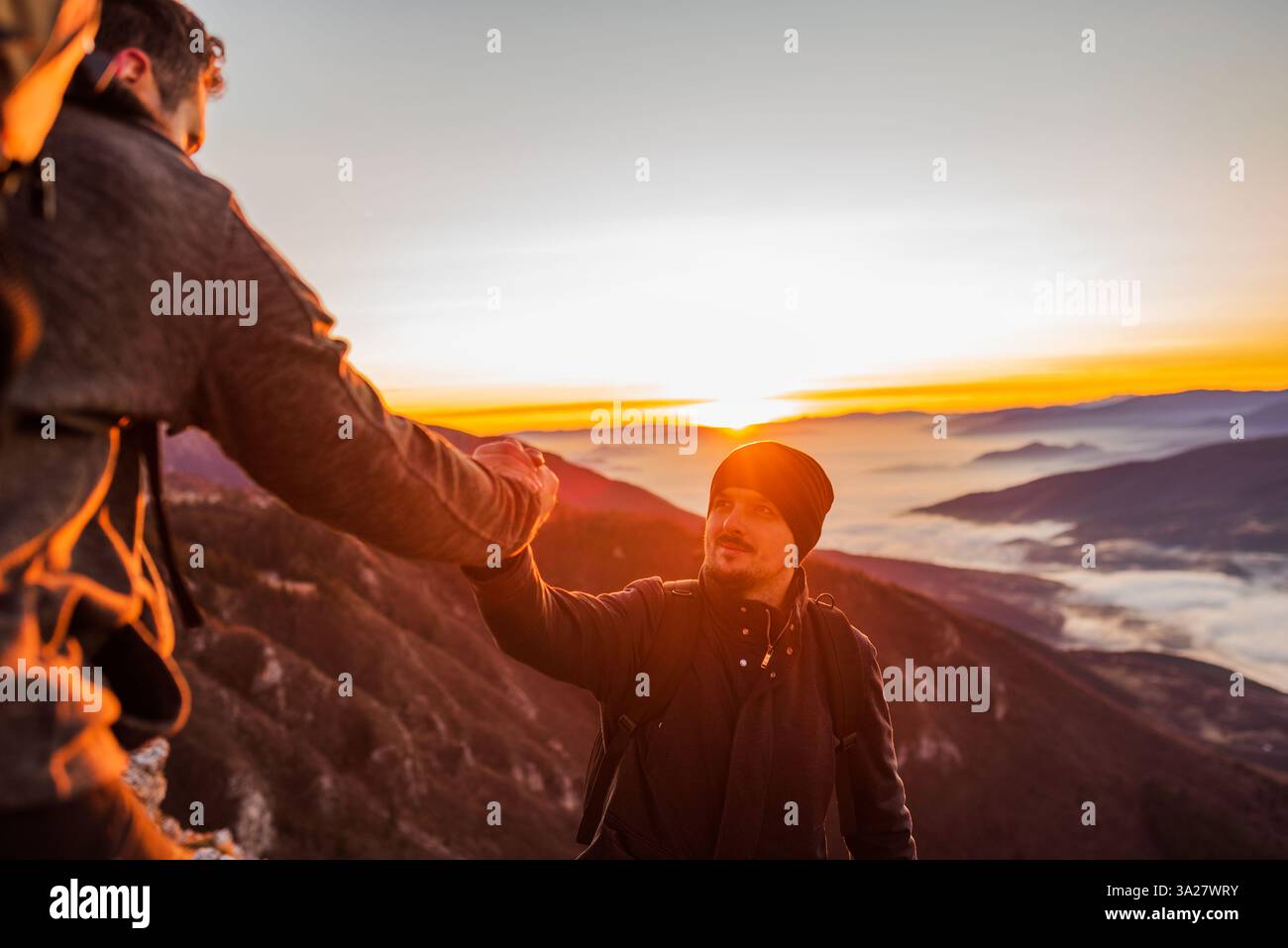 Hiking team people helping each other friend giving a helping hand ...