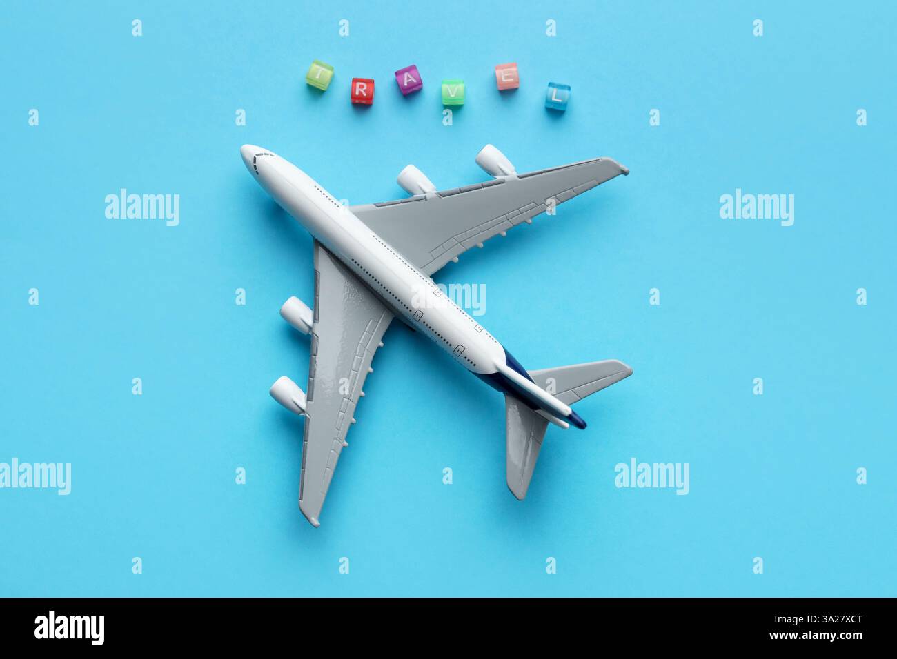 Travel concept. Plane model and colorful cubes on light blue background ...