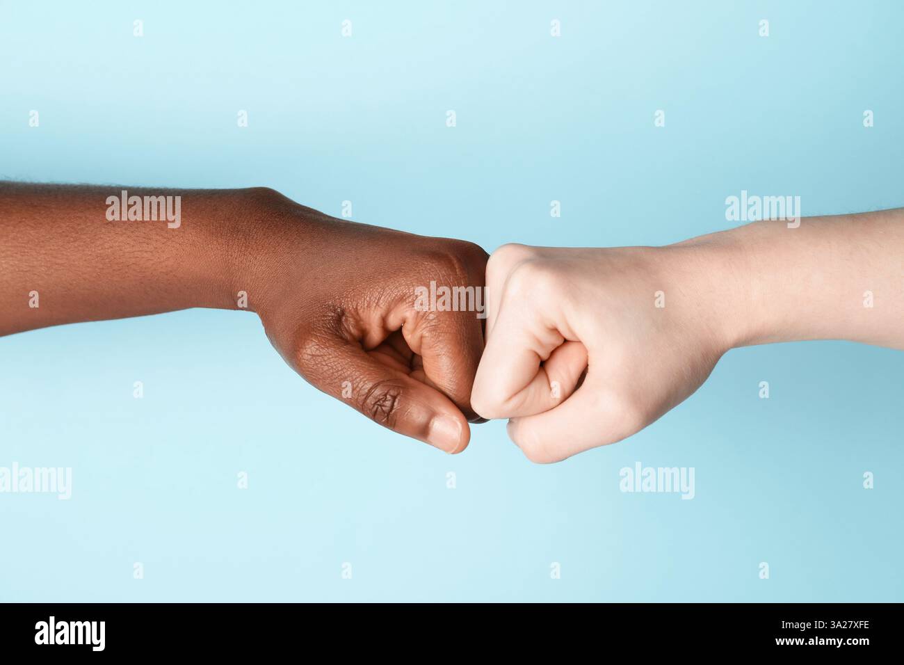 Stop racism. People of different skin colors bumping fists on light ...