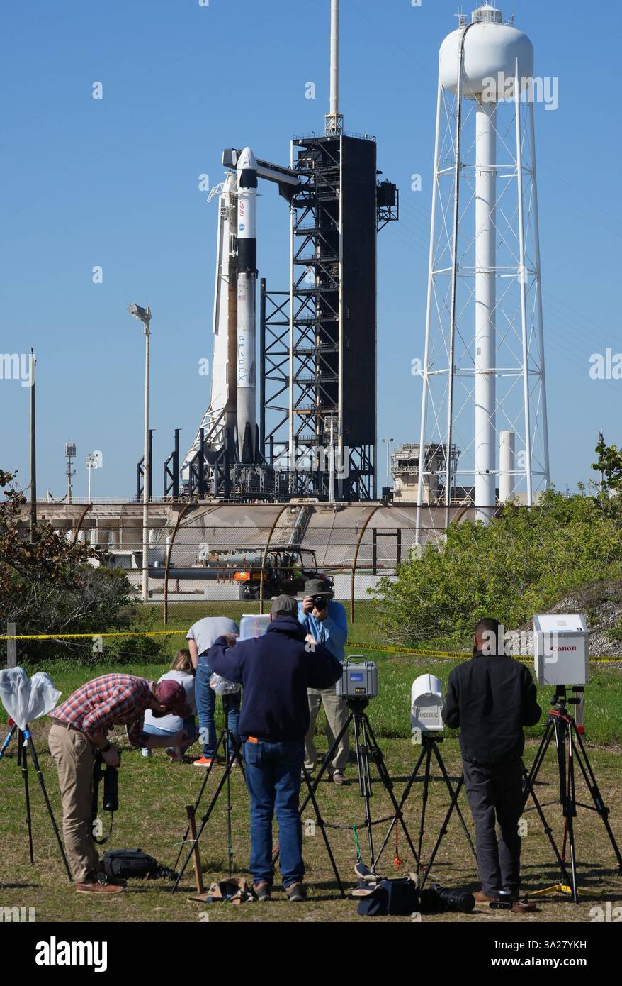 News photographers set up remote cameras before a SpaceX Falcon 9 ...