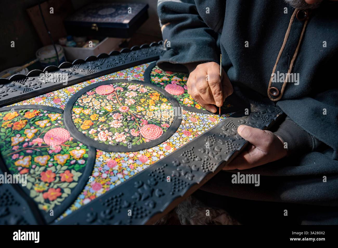 An artisan is seen working on a papier-mâché item at their home-based workshop. Mir Arshad ...