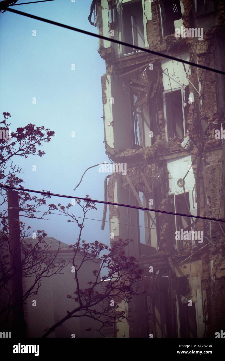 A close-up view of a partially collapsed building, showcasing exposed ...
