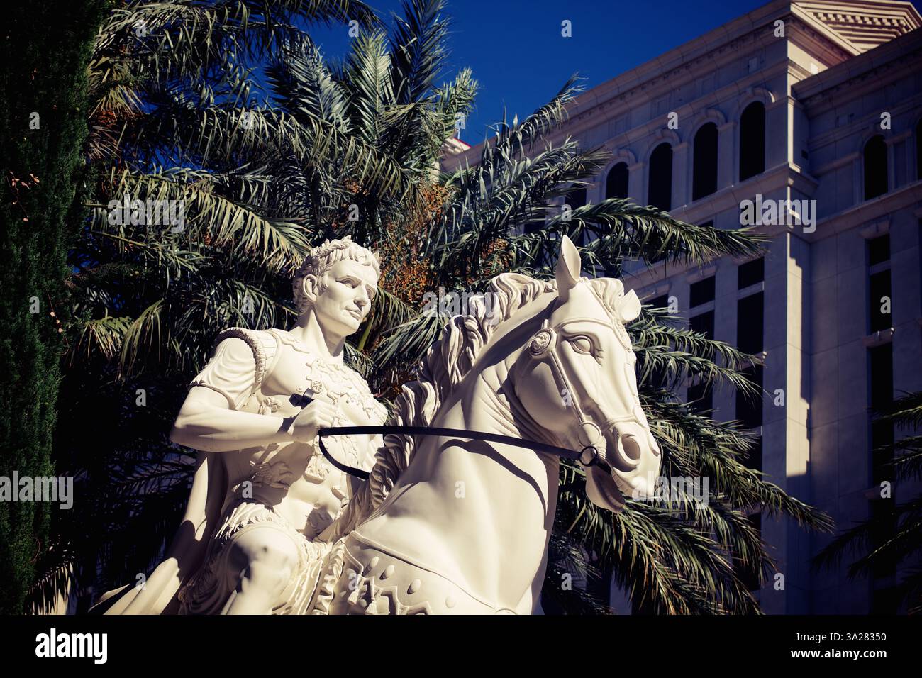 A statue of a Roman emperor on horseback, surrounded by palm trees and ...