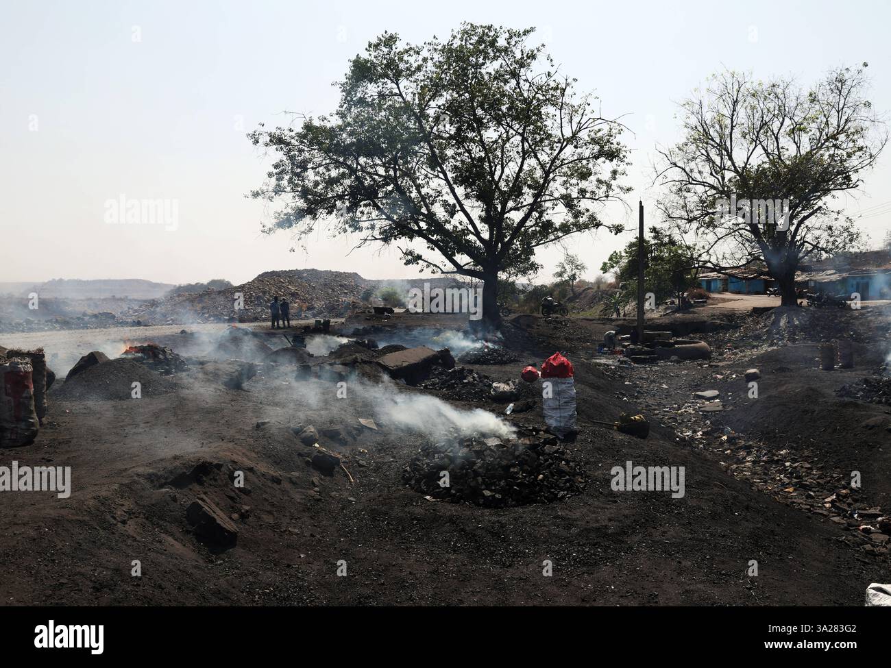 Coal mines of Jharkhand, India Coal scavengers burn coal in an open ...