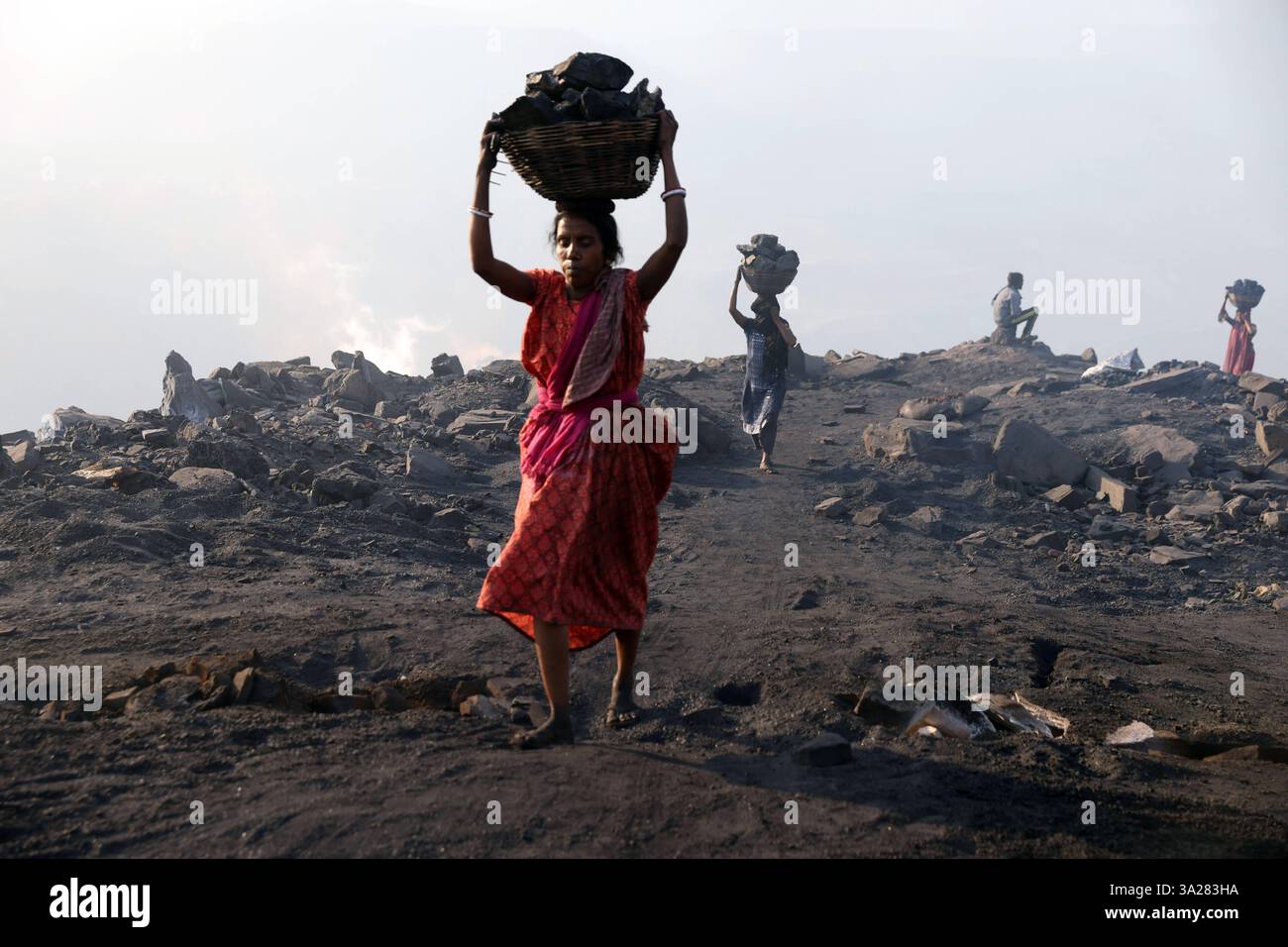 Coal mines of Jharkhand, India Coal scavengers carry baskets of coal in ...