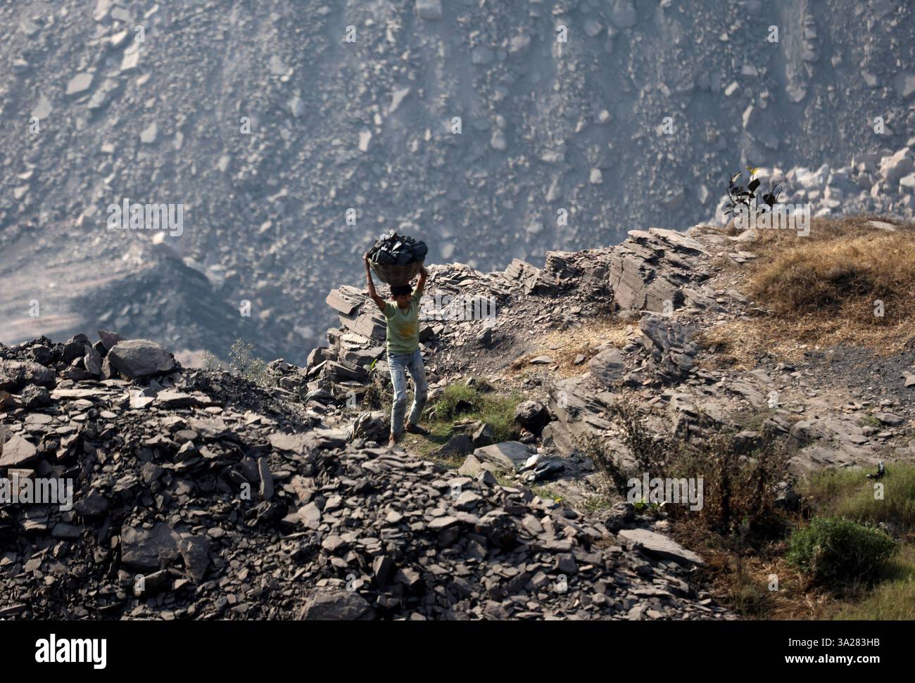 Coal mines of Jharkhand, India A coal scavenger carries a basket of ...