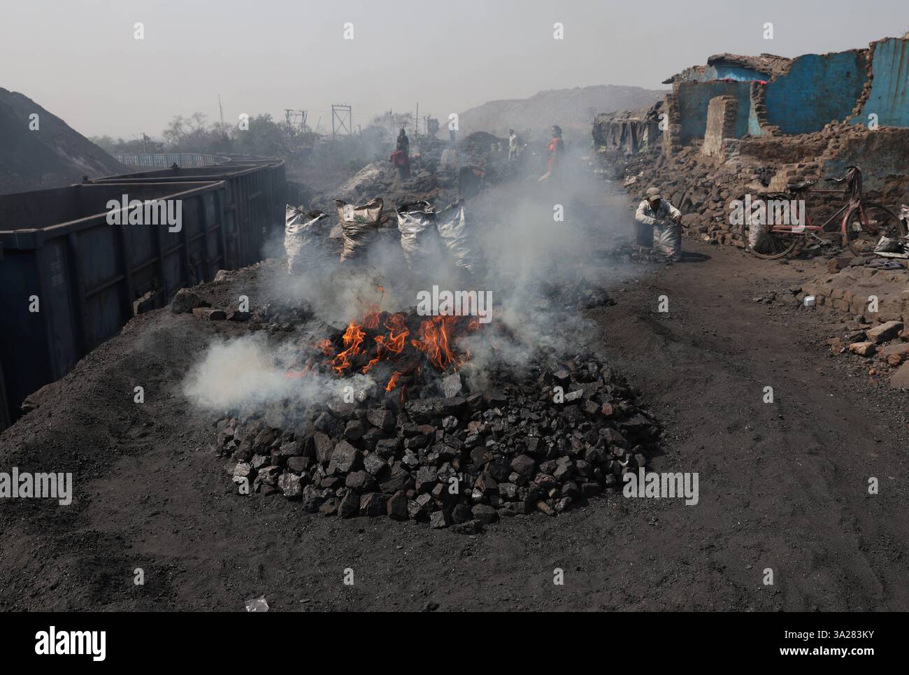 Coal mines of Jharkhand, India Coal scavengers burn coal piles in an ...