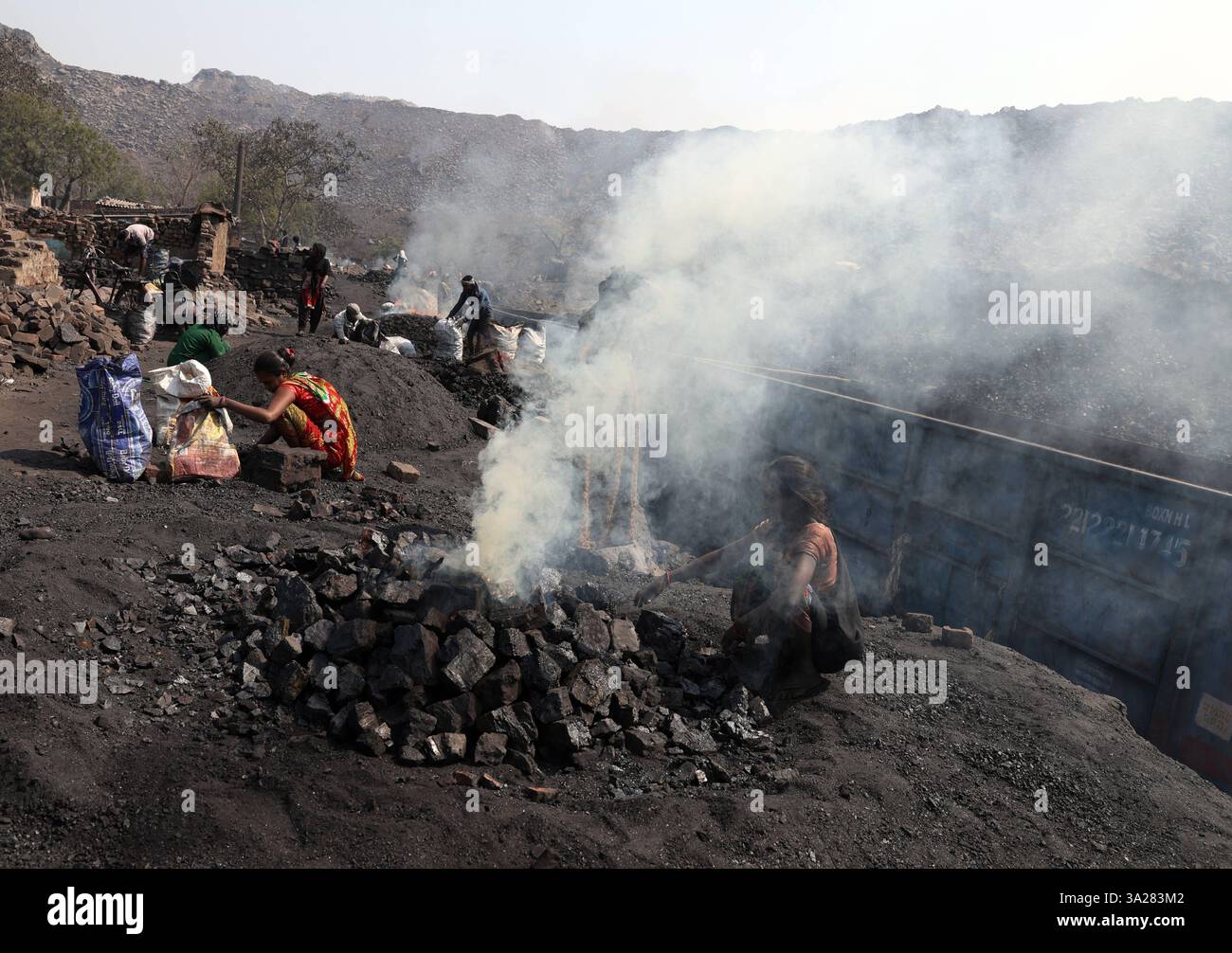 Coal mines of Jharkhand, India Coal scavengers burn coal piles in an ...