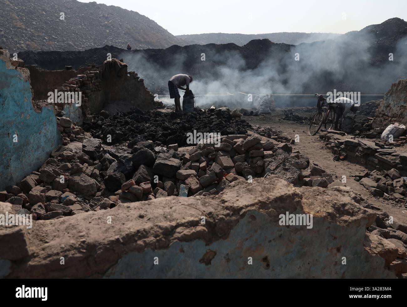 Coal mines of Jharkhand, India Coal scavengers burn coal piles in an ...