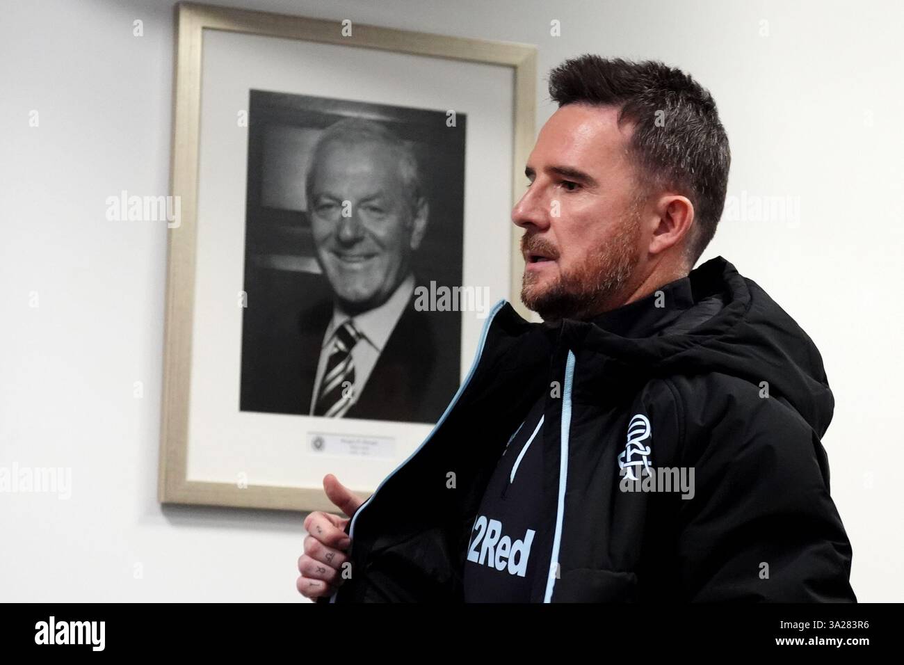 Rangers interim manager Barry Ferguson walks past a picture of former ...