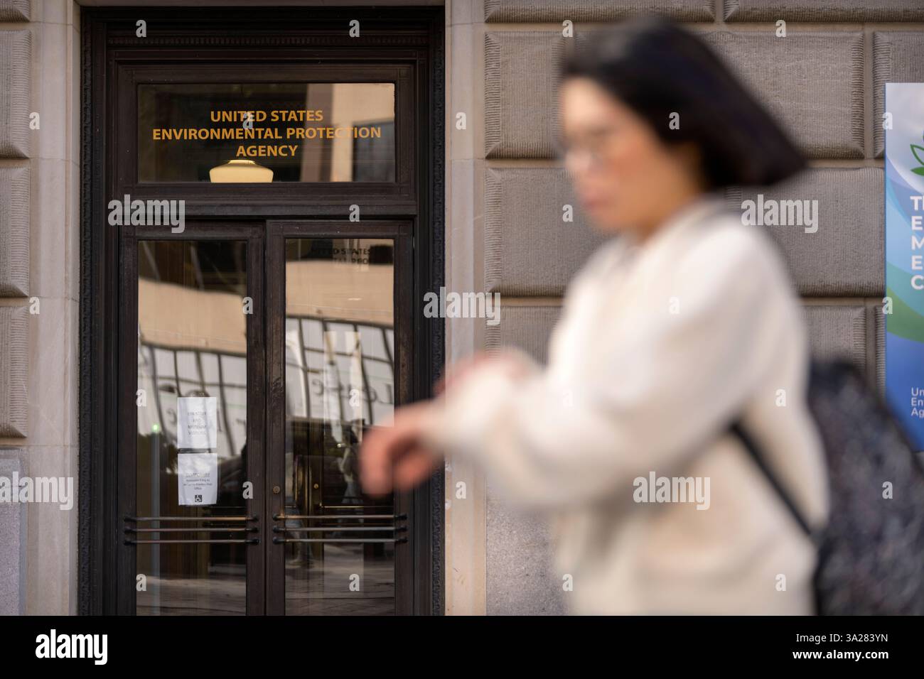 A person walks past the headquarters building of the Environmental ...