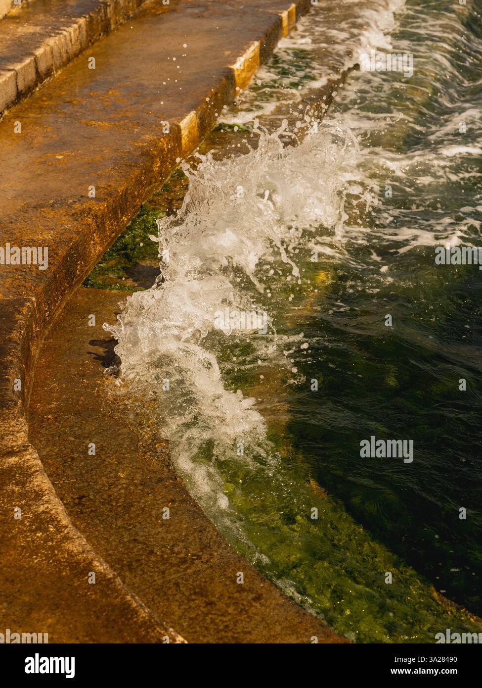 Waves splashing against historic Venetian stone steps, blending nature ...