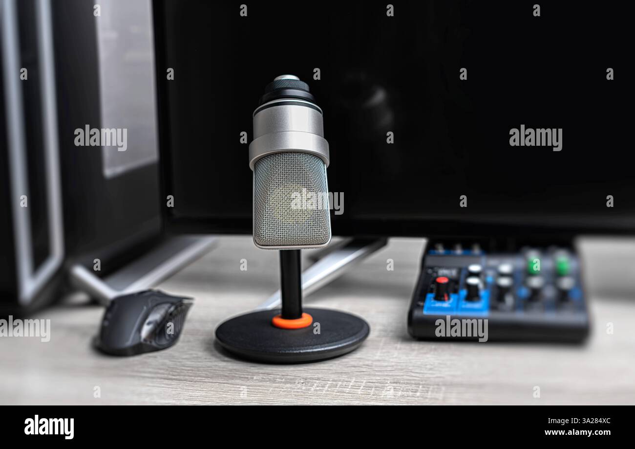 A professional condenser microphone on a desktop stand is set up in a ...