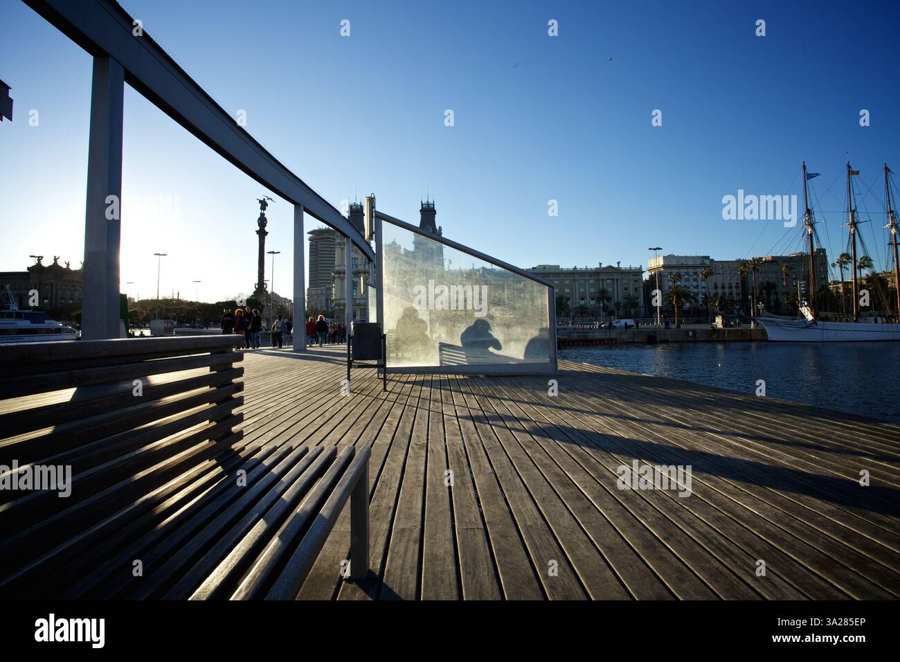 A serene waterfront scene featuring a wooden pier with benches, a ...