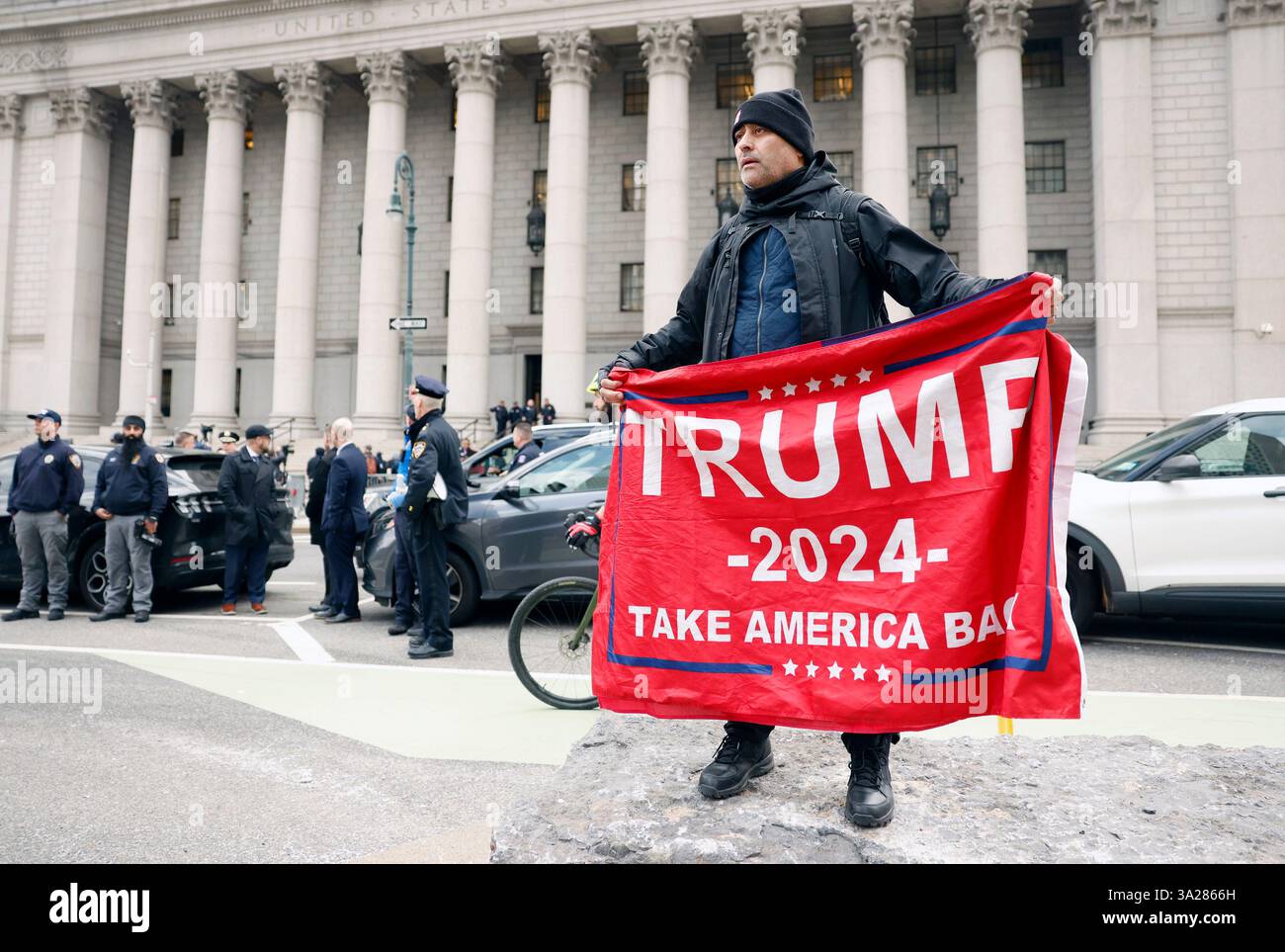 New York, United States. 12th Mar, 2025. A counter-protestor holds up a ...