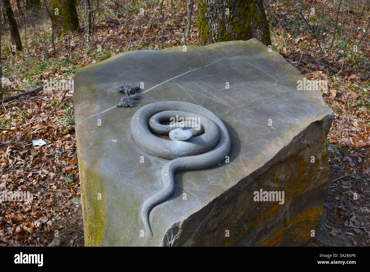 Stone sculpture of a snake king on a large stone block Stock Photo - Alamy