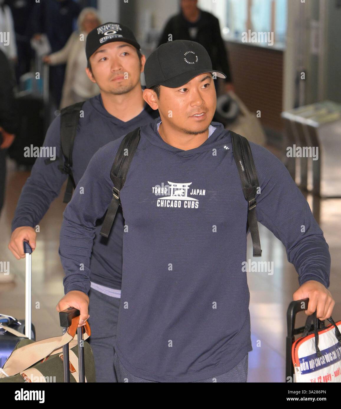 Shota Imanaga, front, and Seiya Suzuki of the Chicago Cubs arrive at ...