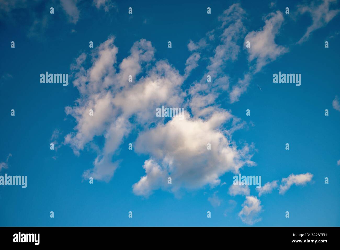 Fluffy clouds across blue hi-res stock photography and images - Alamy