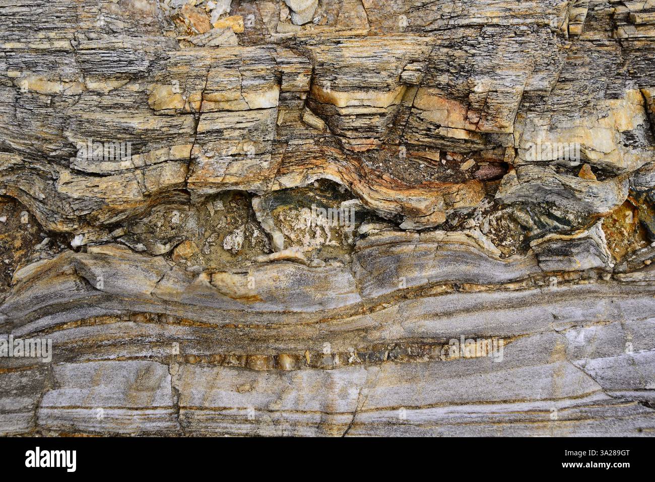 Several layers of stratified rock with signs of volcanic activity Stock ...