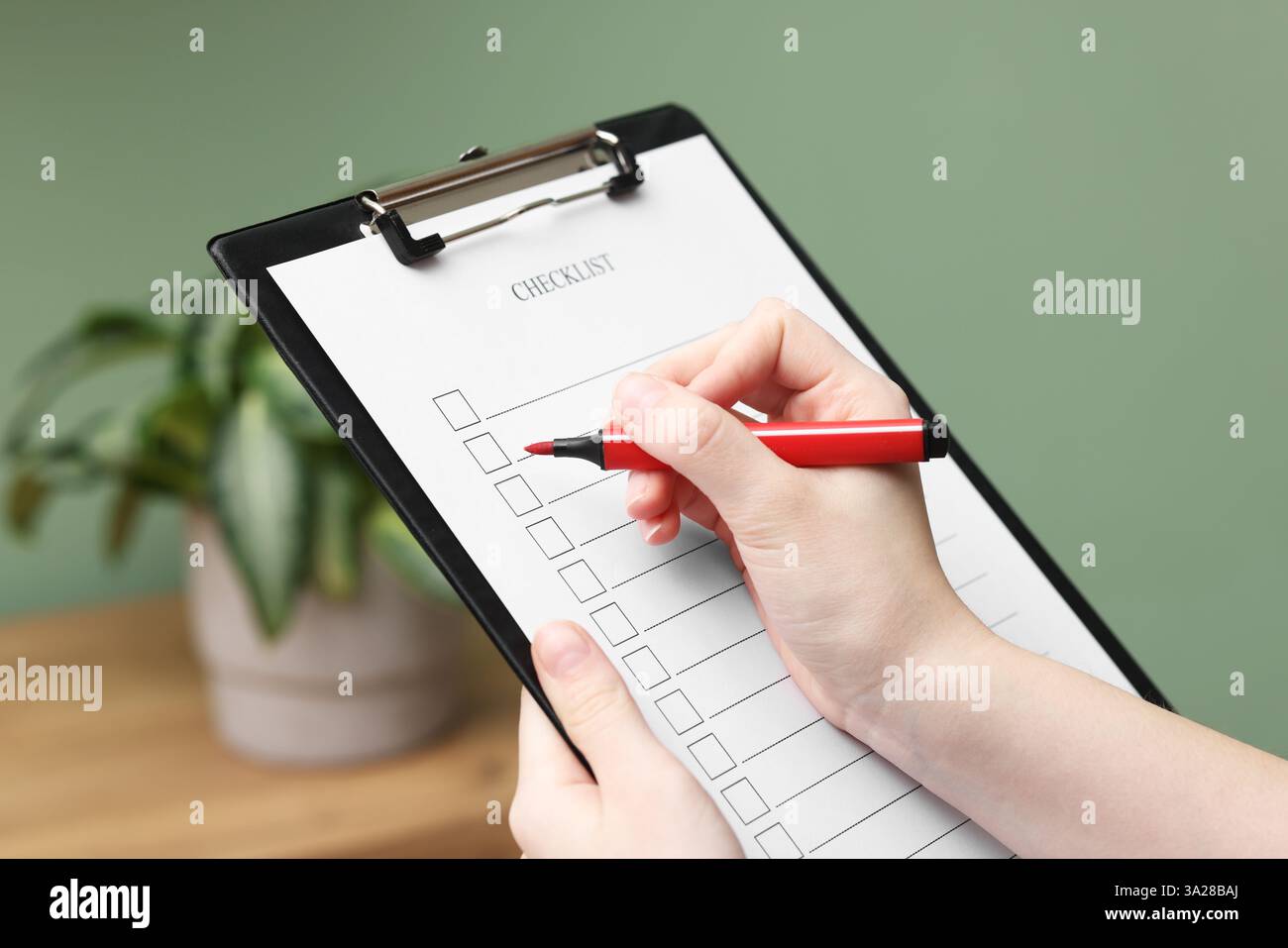 Woman filling Checklist with marker indoors, closeup Stock Photo - Alamy