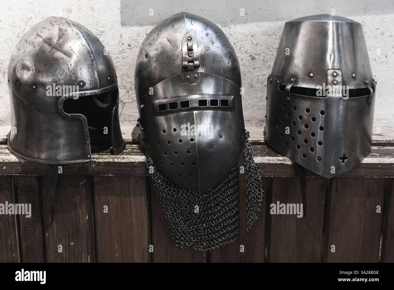 An intriguing display featuring three medieval helmets, crafted from ...