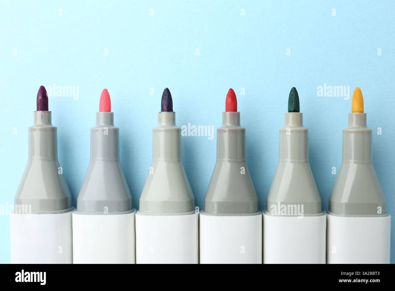 Colorful markers on light blue background, flat lay Stock Photo - Alamy