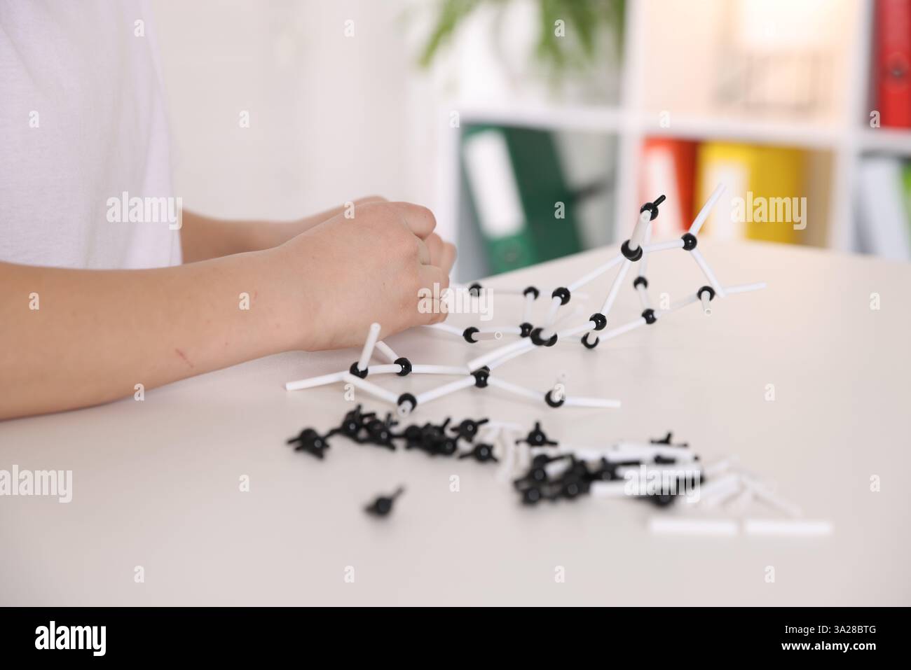 Boy making DNA structure model at desk indoors, closeup Stock Photo - Alamy