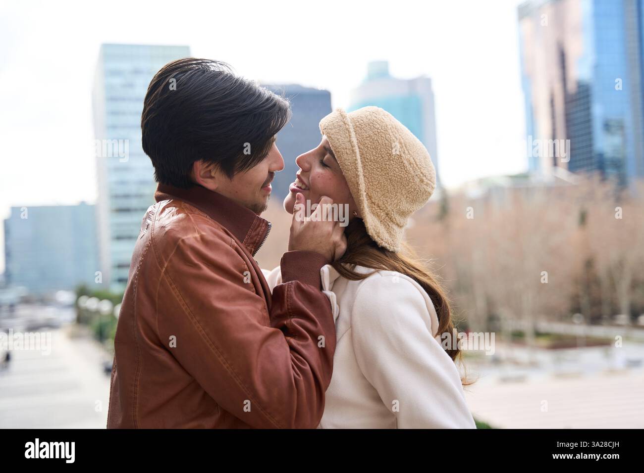 Man gently caressing woman's face, sharing an intimate moment with ...