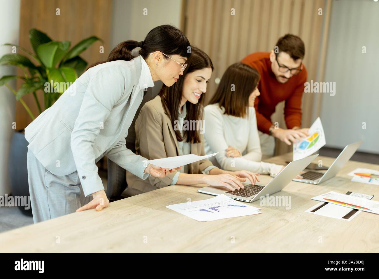 A diverse group of professionals engages in a dynamic brainstorming ...