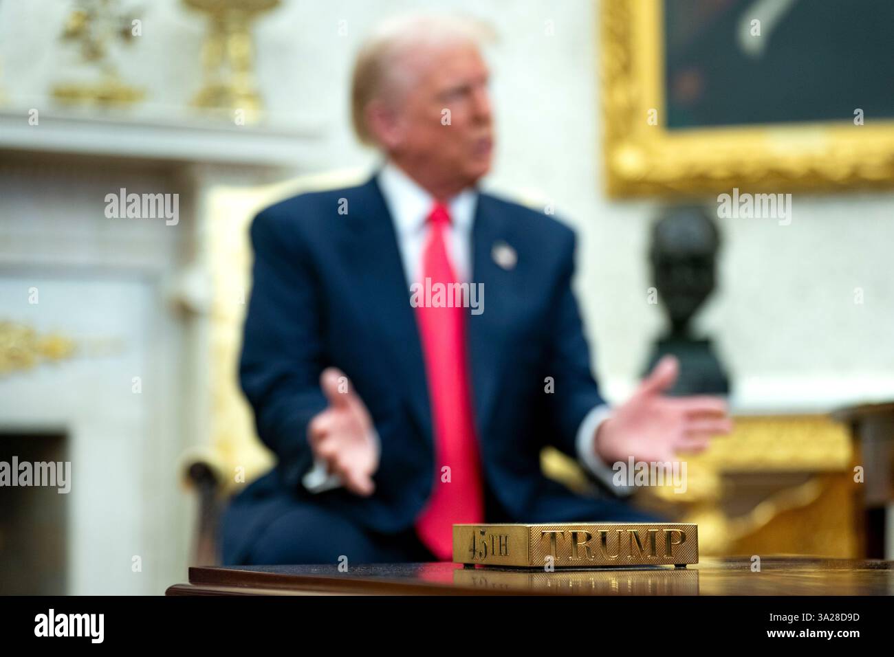 Golden coasters engraved with “45th” and “Trump” lay on a coffee table ...