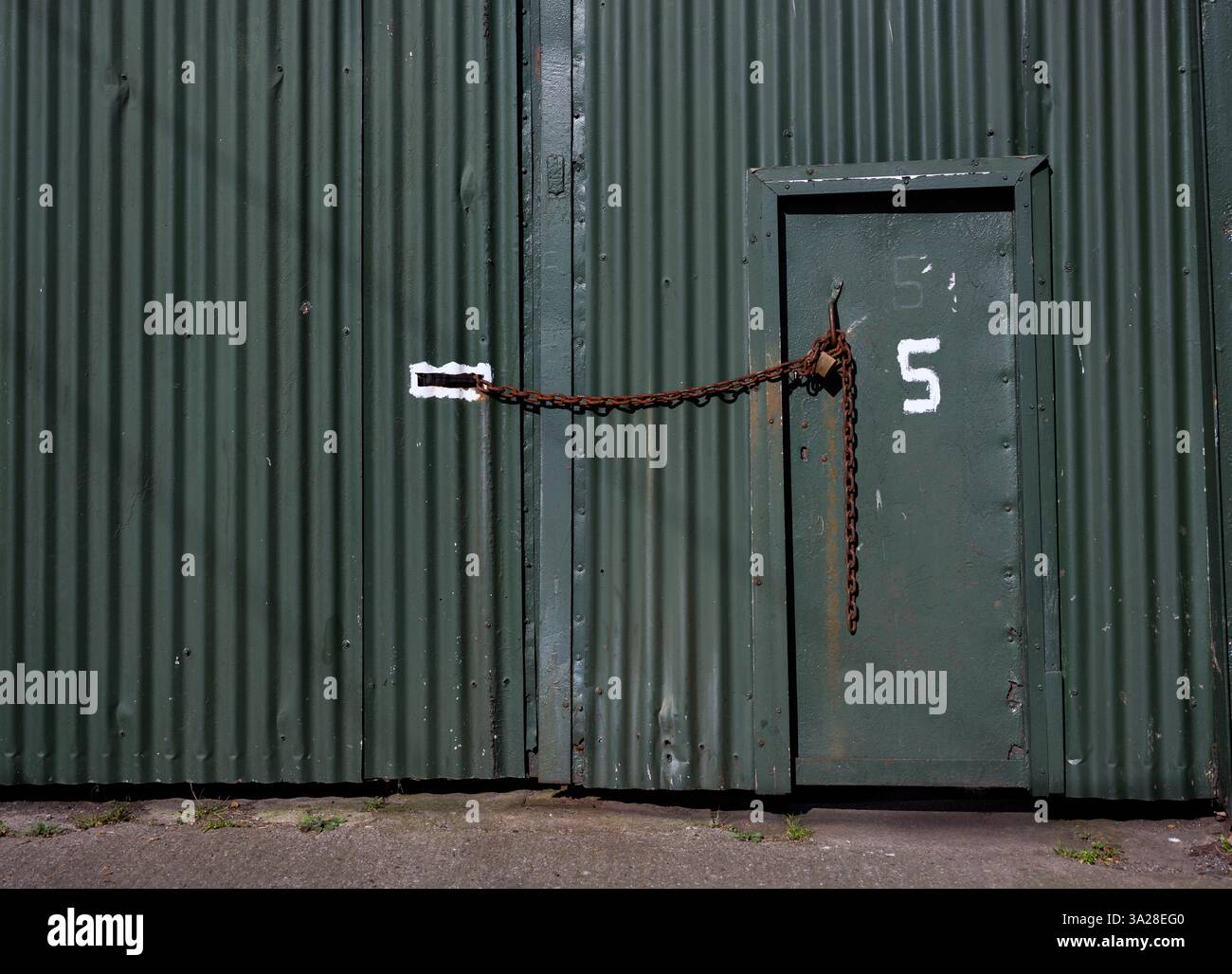 A metal gate secured with a chain and lock Stock Photo - Alamy