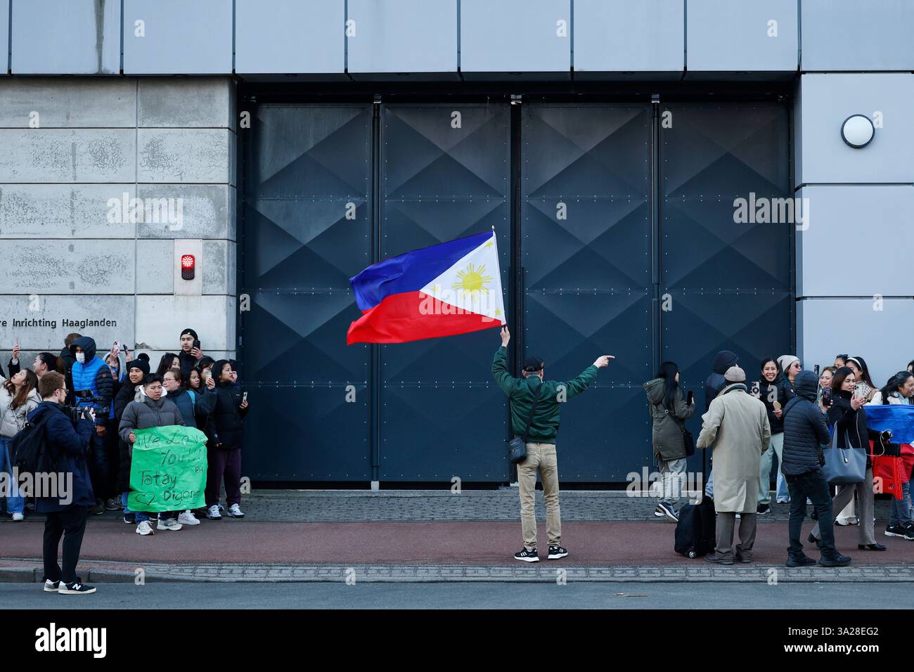 A supporter of former Philippine President Rodrigo Duterte waves a flag ...