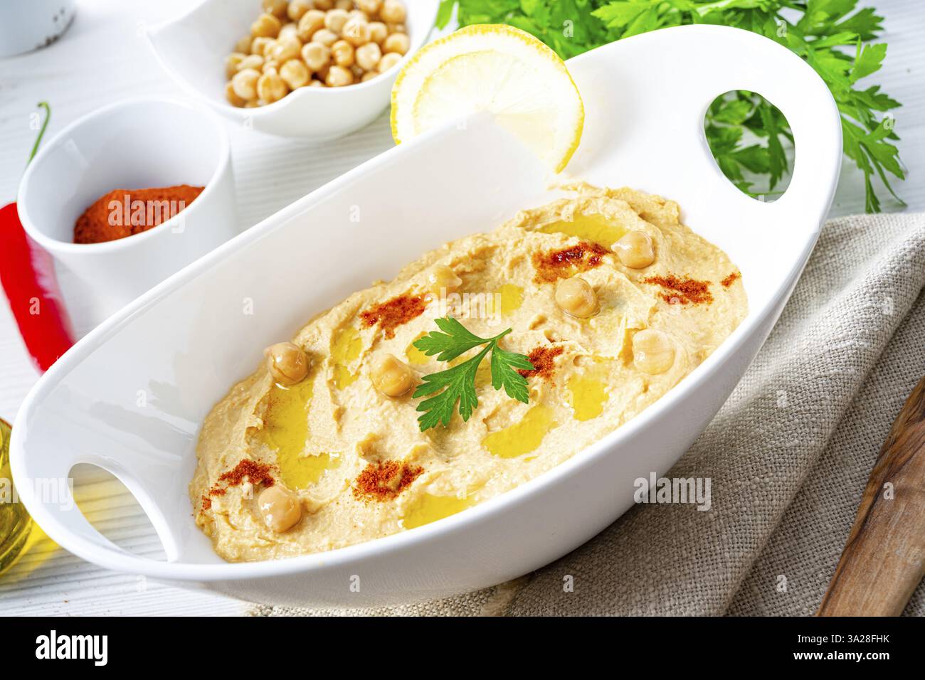 Hummus paste with lemon and chilli on a white background Stock Photo ...