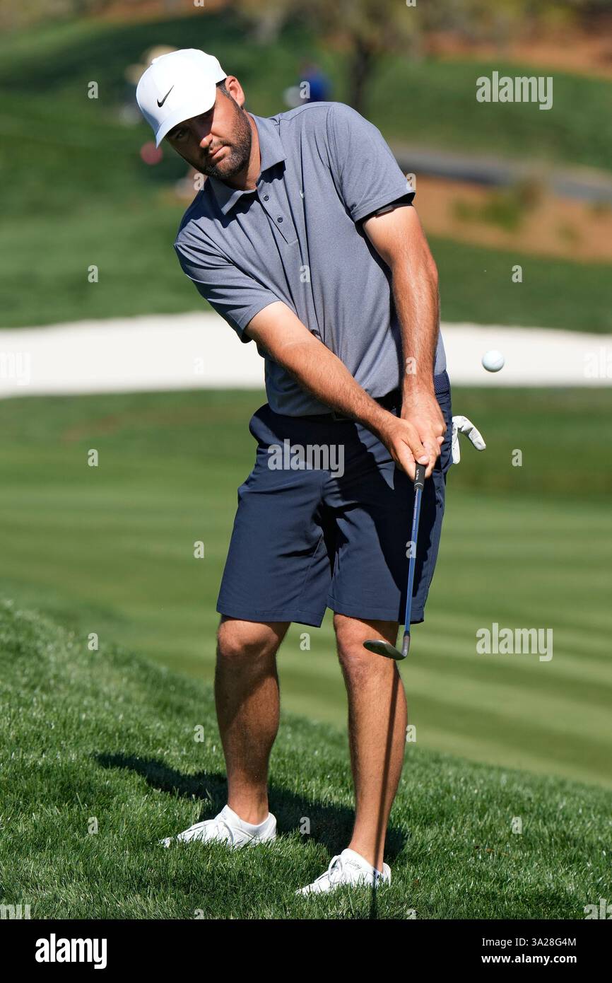 Scottie Scheffler chips from the side of a hill on the fifth hole ...