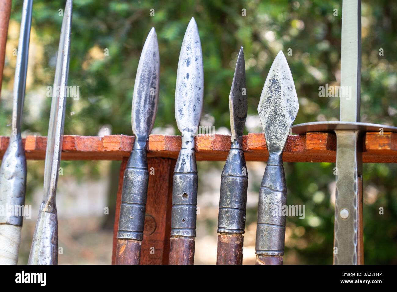 Iron spearheads of various shapes with wooden handles Stock Photo - Alamy