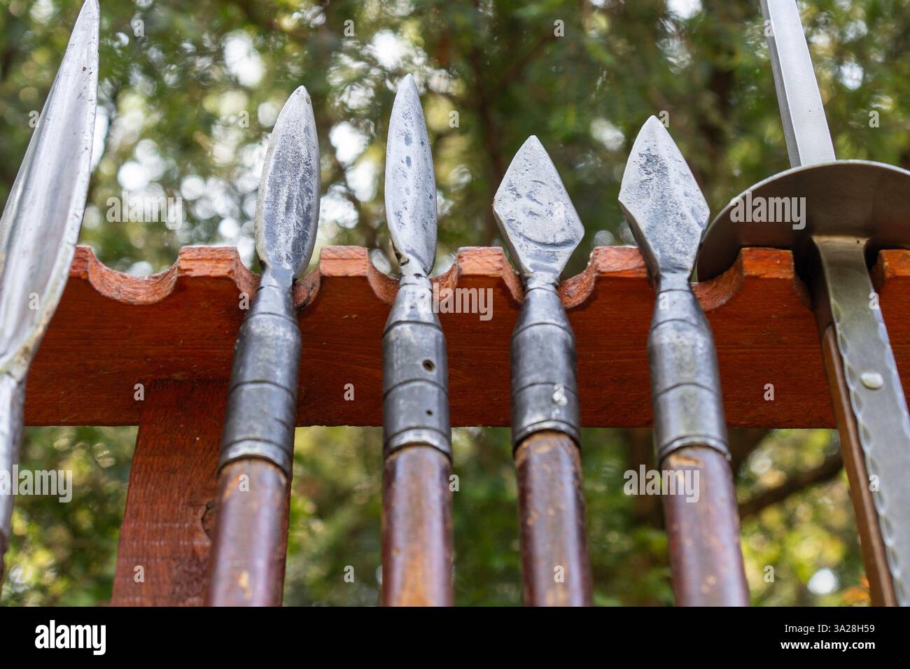 Iron spearheads of various shapes with wooden handles Stock Photo - Alamy