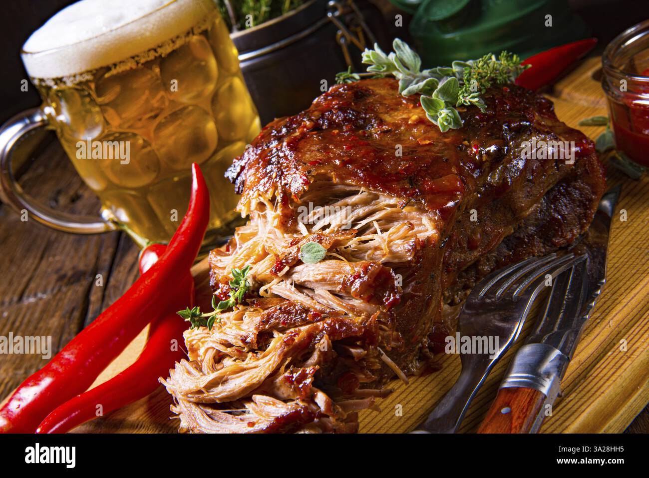 Pork with beer sauce pulled from the oven Stock Photo - Alamy